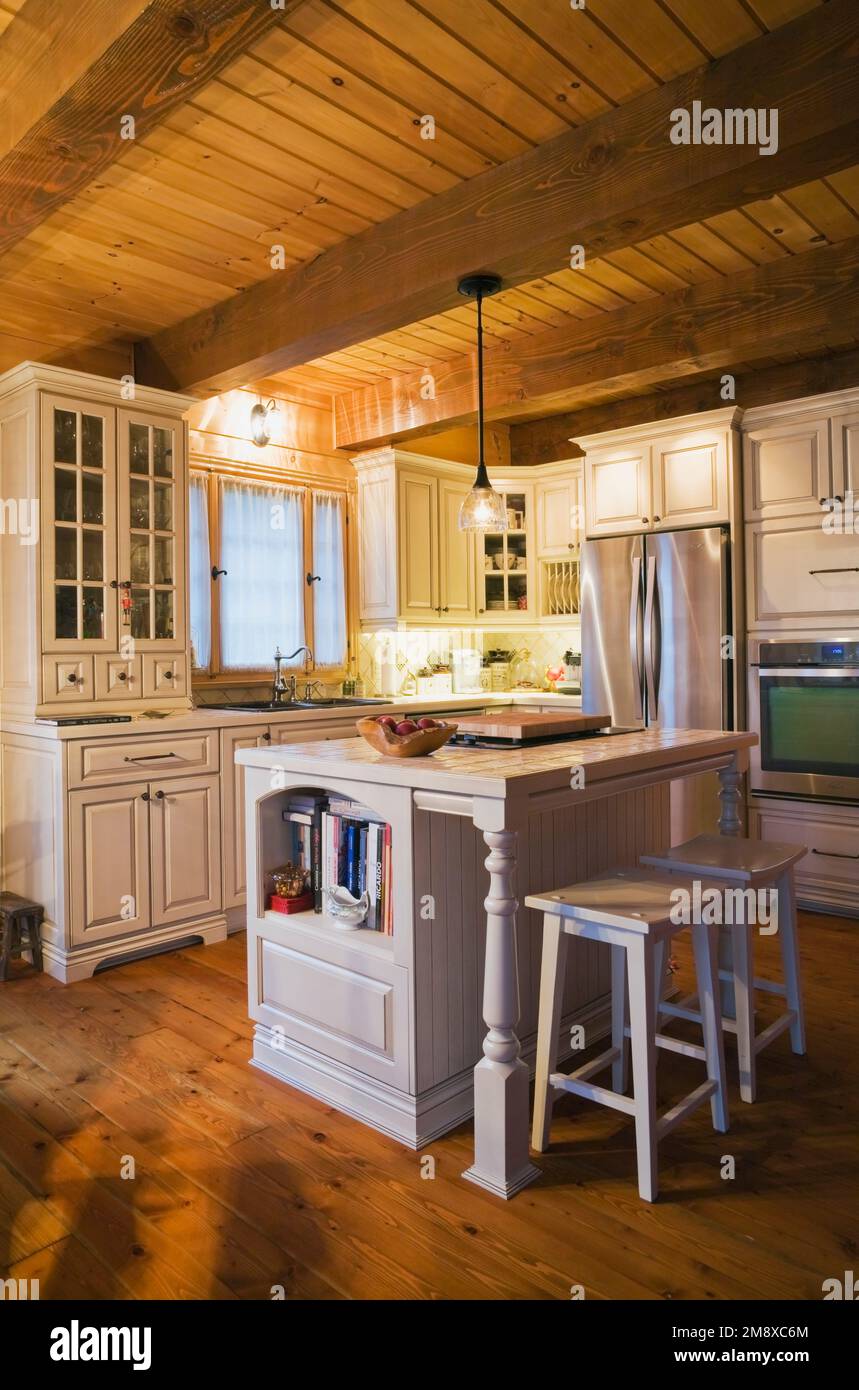Kitchen with antique style cream white wooden cabinets, island with ...