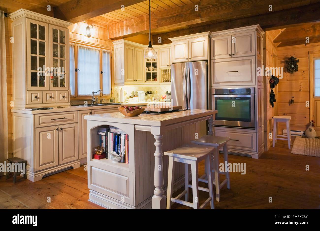 Kitchen with antique style cream white wooden cabinets, island with ...