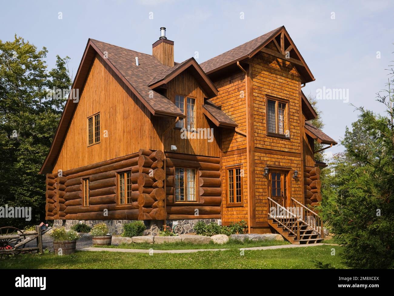 Side and rear view of Scandinavian style log home with vertical wood ...