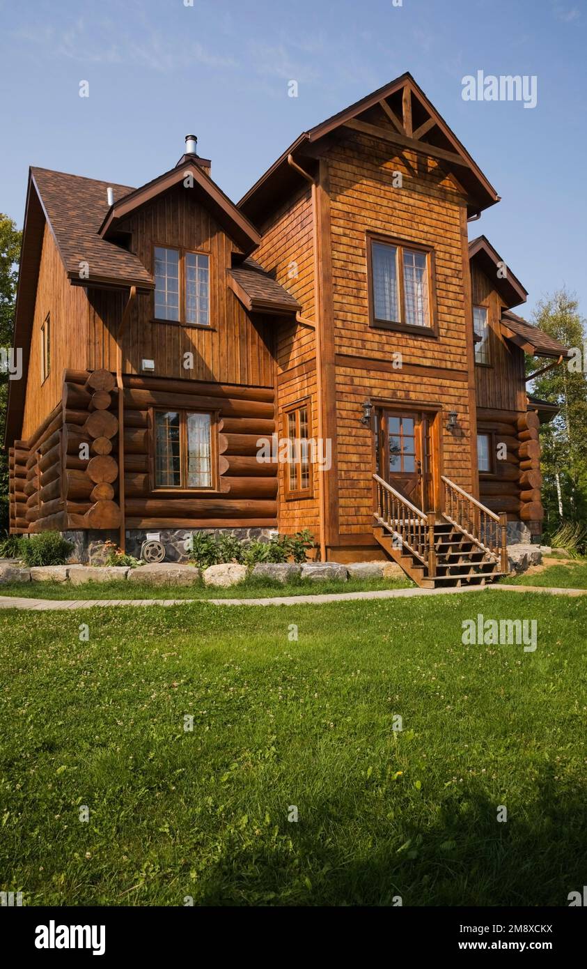 Side and rear view of Scandinavian style log home with vertical wood ...