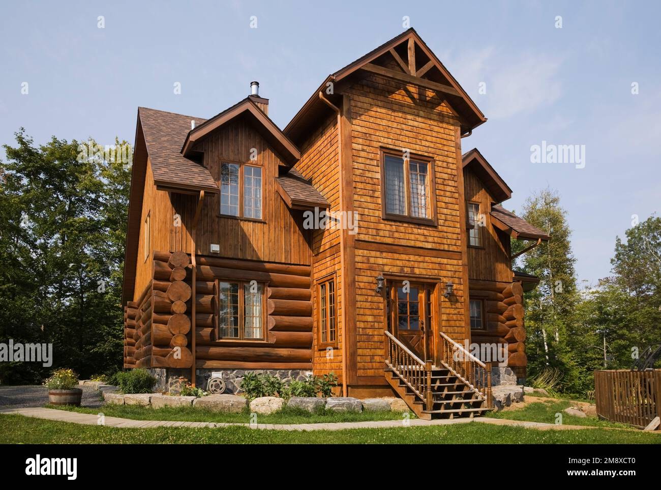 Side and rear view of Scandinavian style log home with vertical wood ...