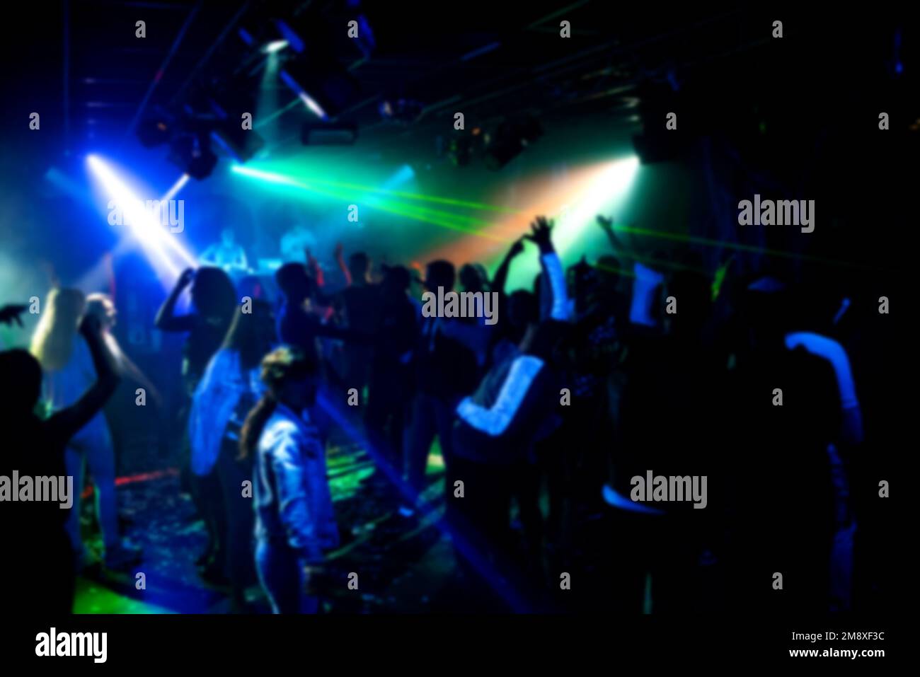 blurred silhouettes of people dancing in a nightclub on the dance floor ...