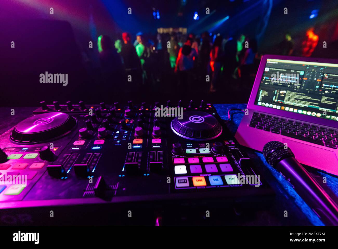 music controller DJ in the booth on the background of the dance floor ...