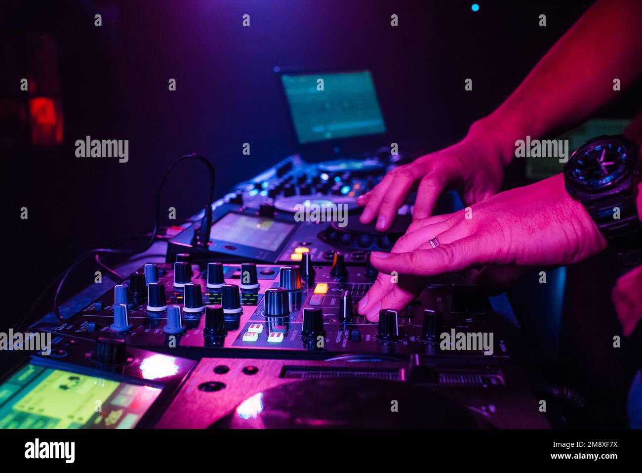 DJ hand mixes on a professional mixer at a party in a nightclub Stock ...
