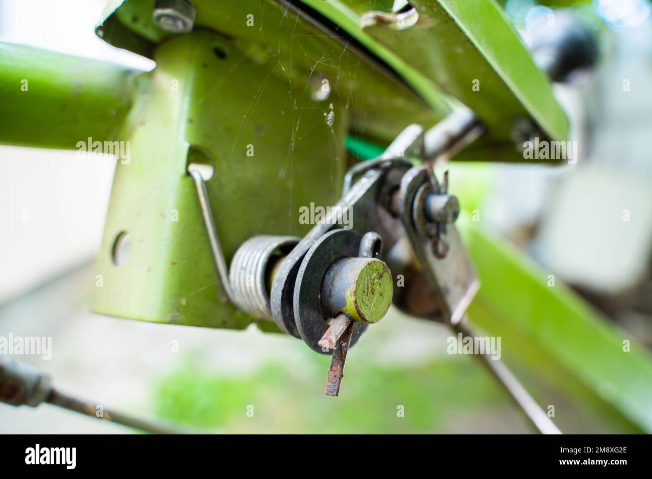 The control lever on a walk-behind tractor close-up on a blurred ...