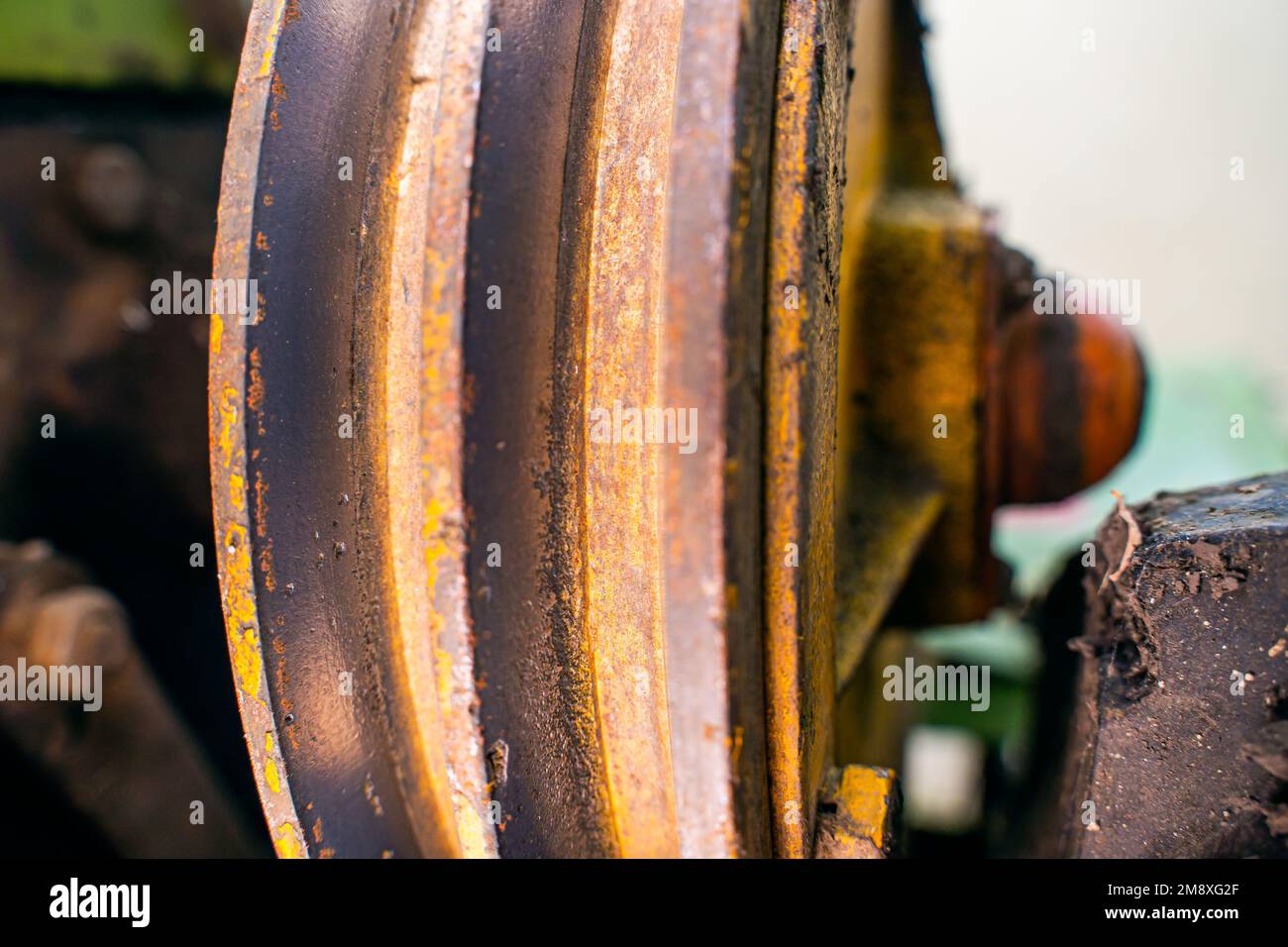 V-pulley with corrosion in the recesses close-up. Old worn double ...