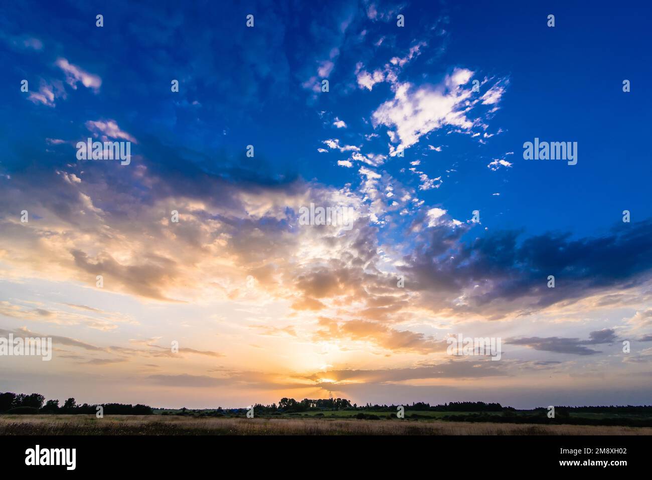 summer morning landscape with colorful sunrise and sun rays in the sky ...