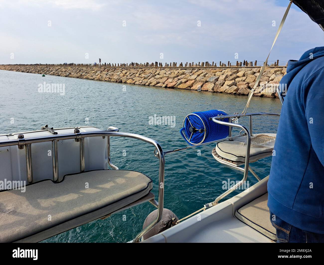 Yacht Sailing Near Wave Breakers Stock Photo - Alamy