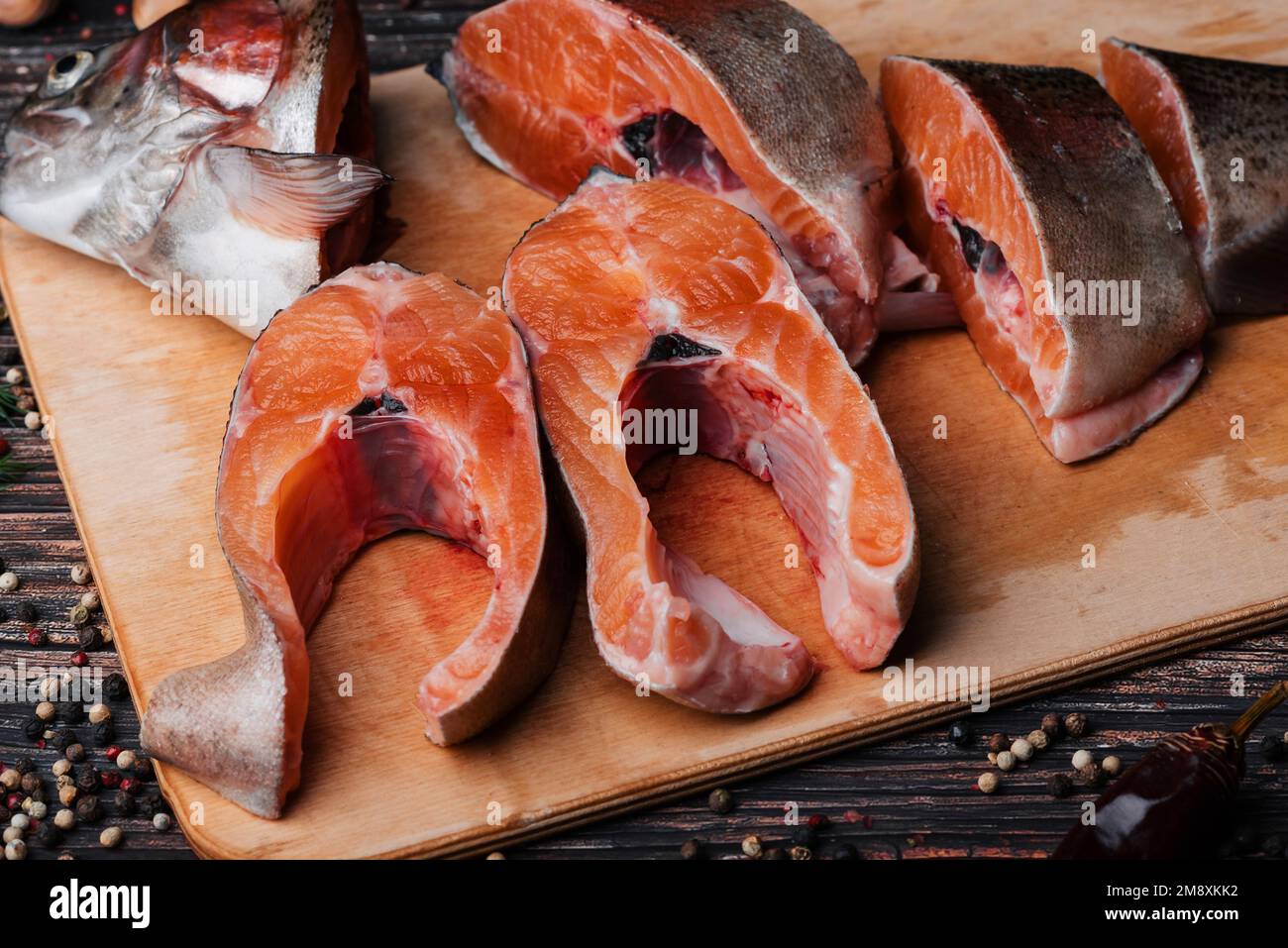 pieces of red fish on the Board on the table in the kitchen for cooking ...