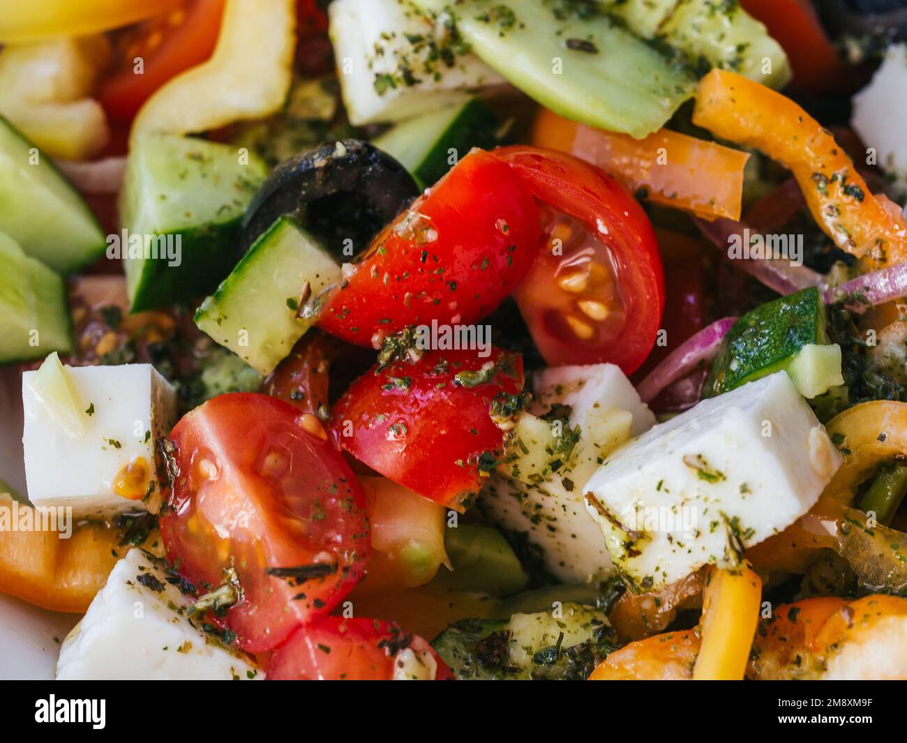 Greek salad with tomatoes, cucumbers, bell peppers, feta cheese, olives ...