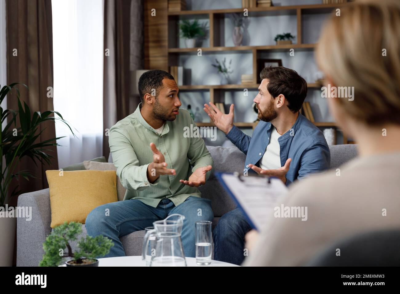 A family psychologist conducts a session in a beautiful office. LGBT ...