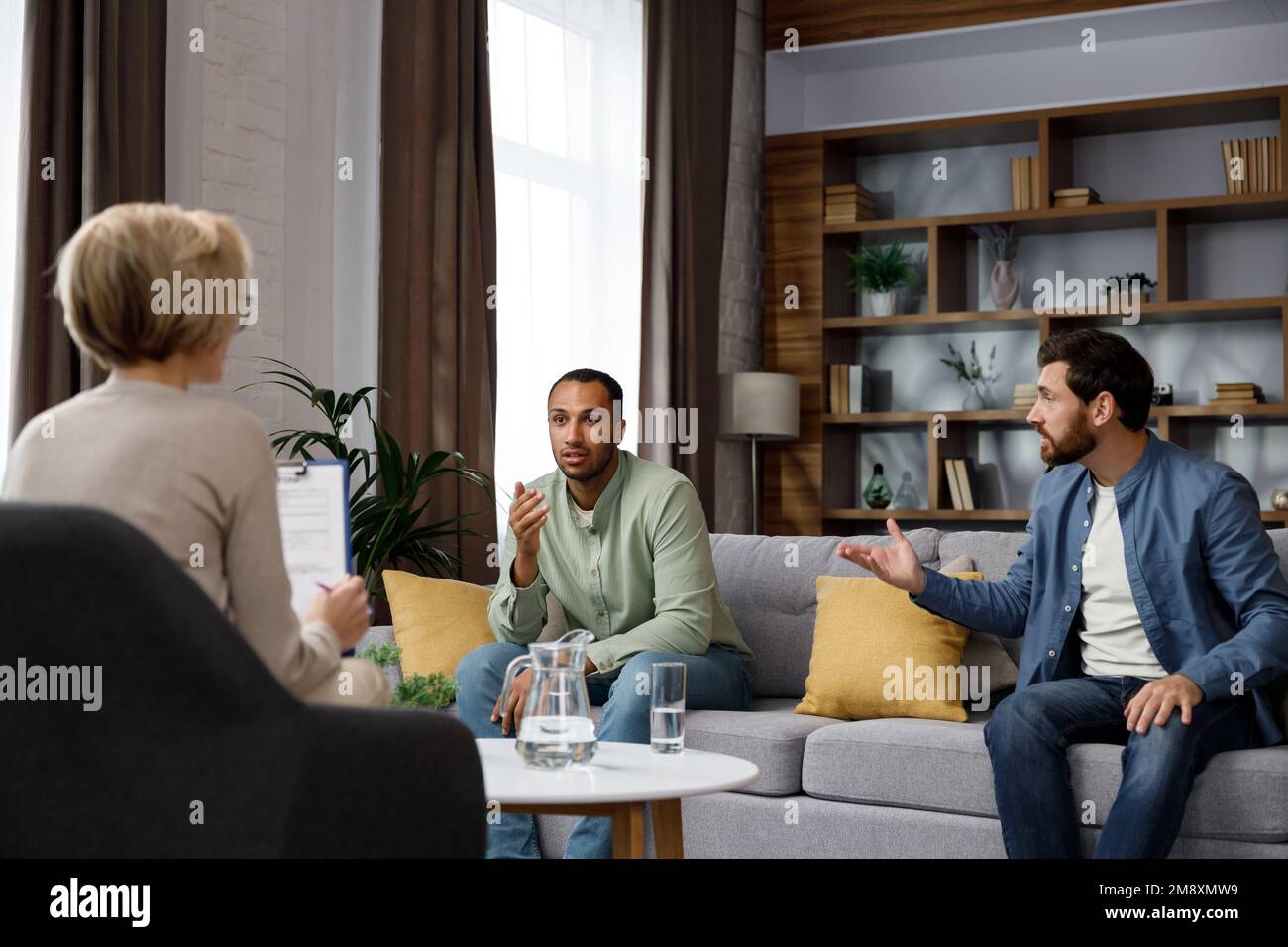 Family quarrel at the reception at the psychologist. LGBT couple at a ...