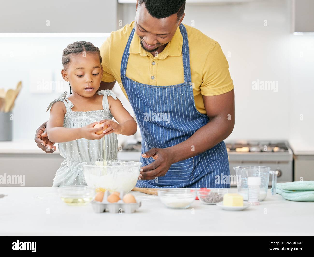 Nice and easy now. a young father bonding with his daughter and helping ...