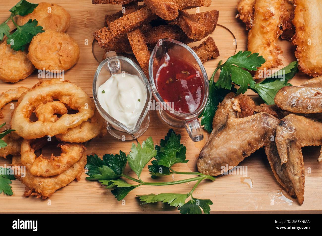 onion rings, crackers, chicken wings and other beer snacks Stock Photo ...