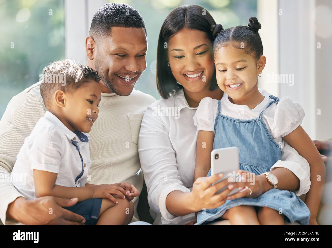 The best choice I made was saying I do. a family using a smart phone at ...