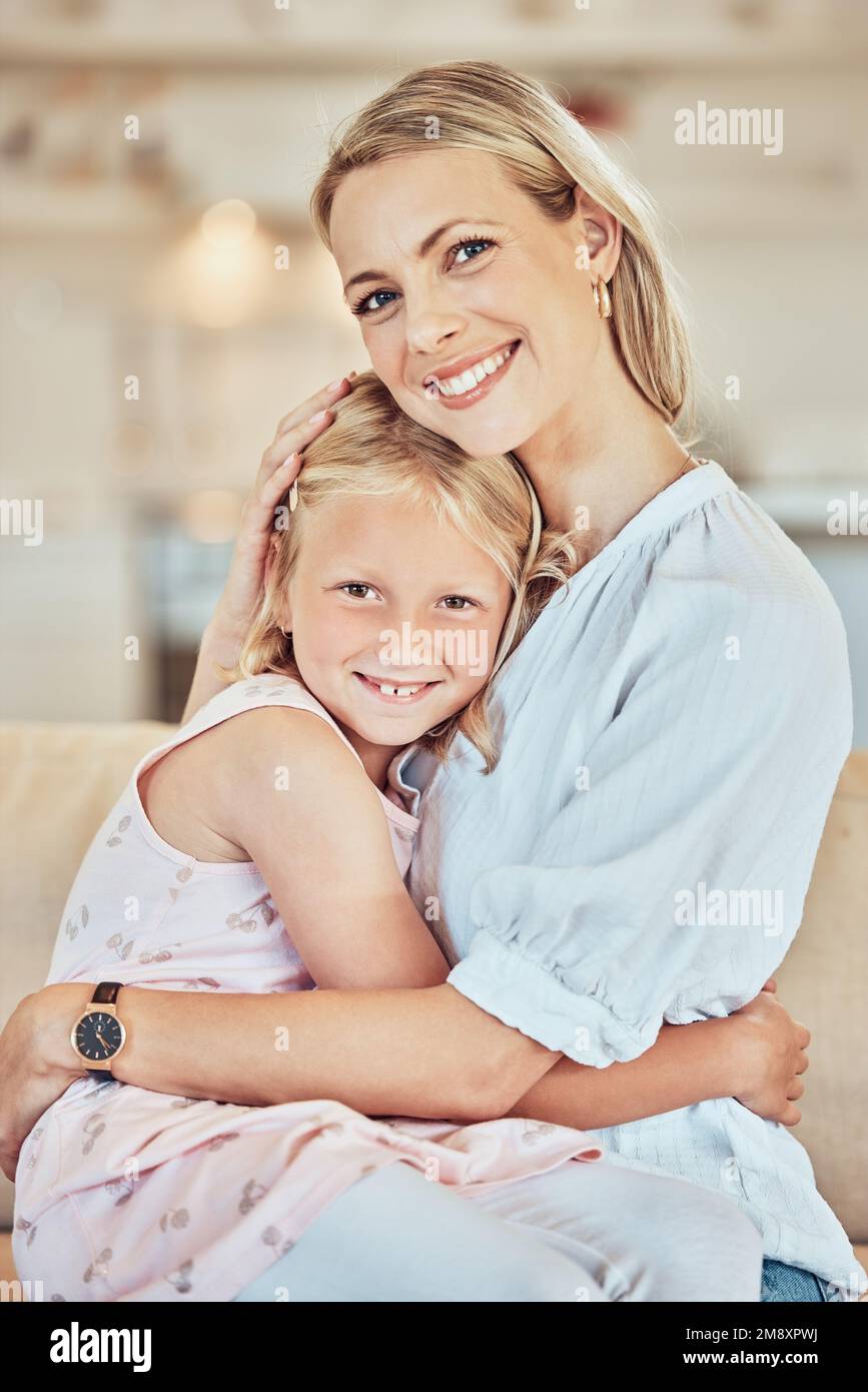 Portrait of mother hugging her daughter. Caucasian woman embracing her child. Little girl being ...