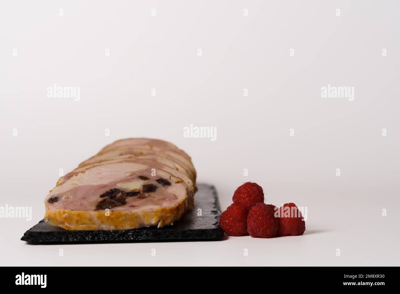 Close-up of a chicken stuffed with raspberry and goat cheese with a ...