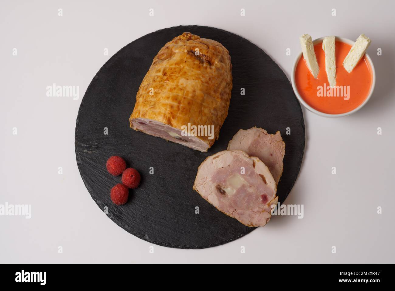 Close-up of a chicken stuffed with raspberry and goat cheese with a ...