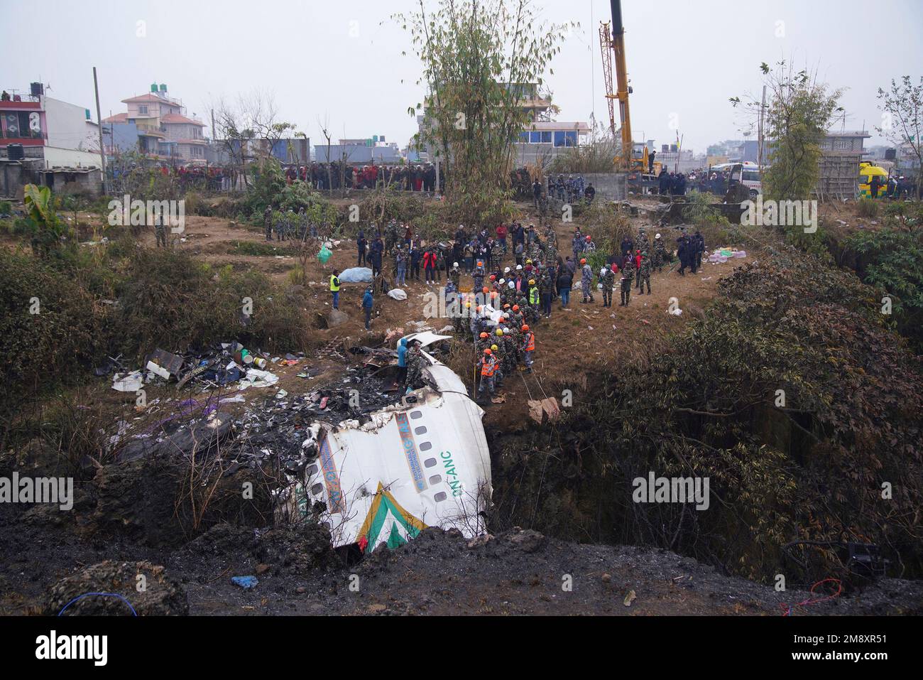 Rescuers Scour The Crash Site In The Wreckage Of A Passenger Plane In