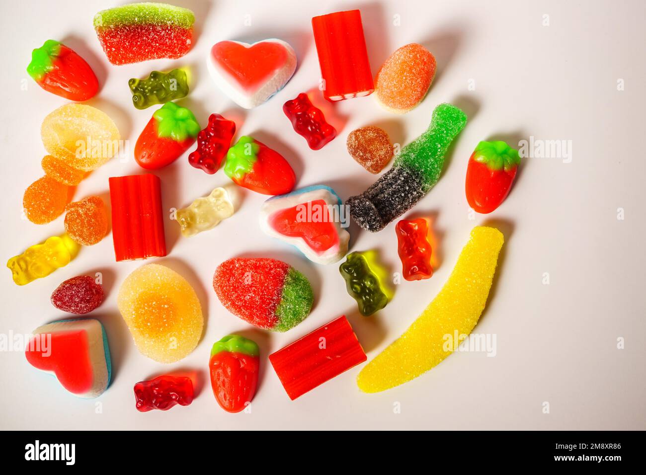 Various types of assorted jelly candy on white background Stock Photo ...