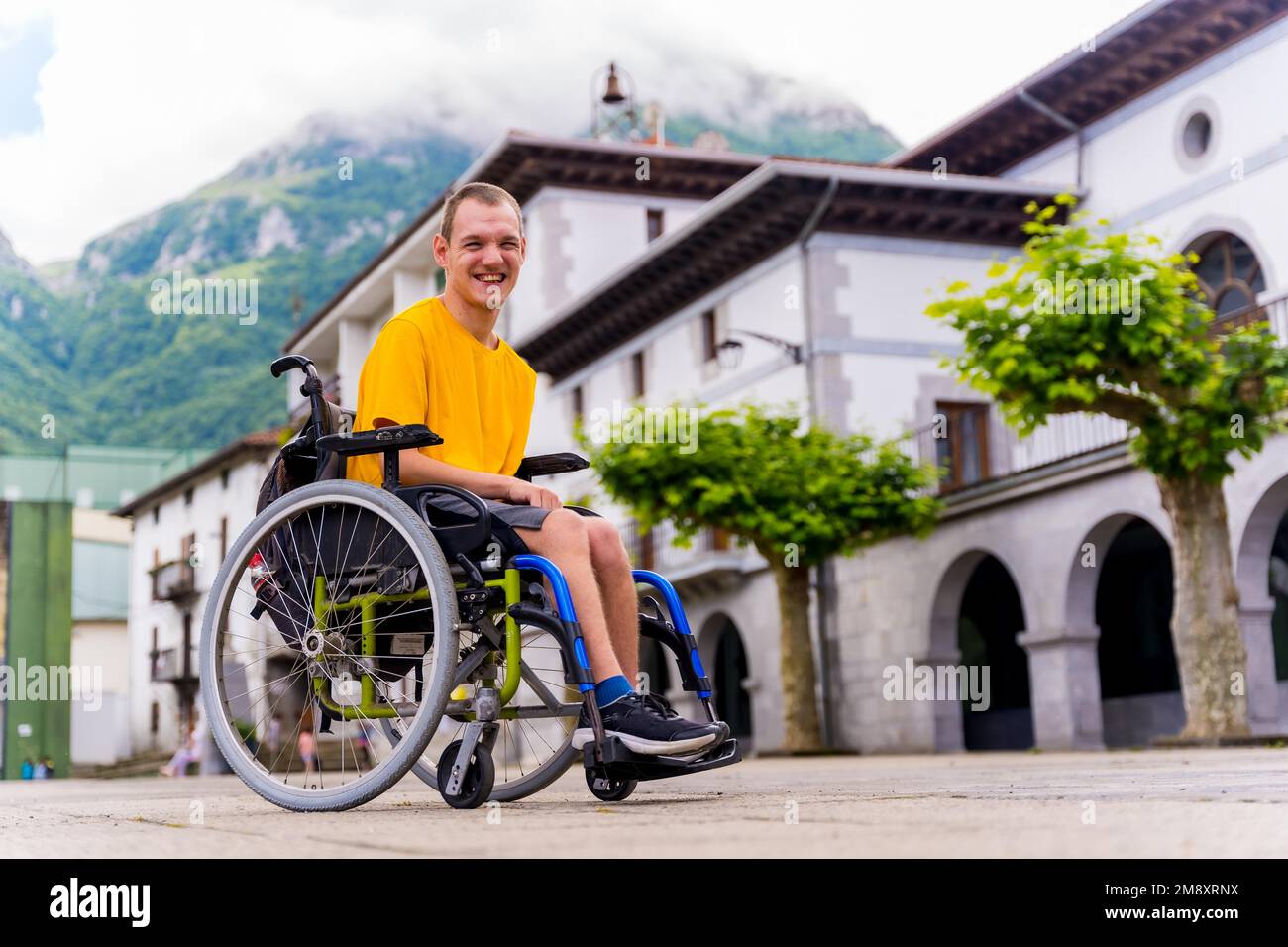 Portrait of a disabled person in a wheelchair walking through the town ...