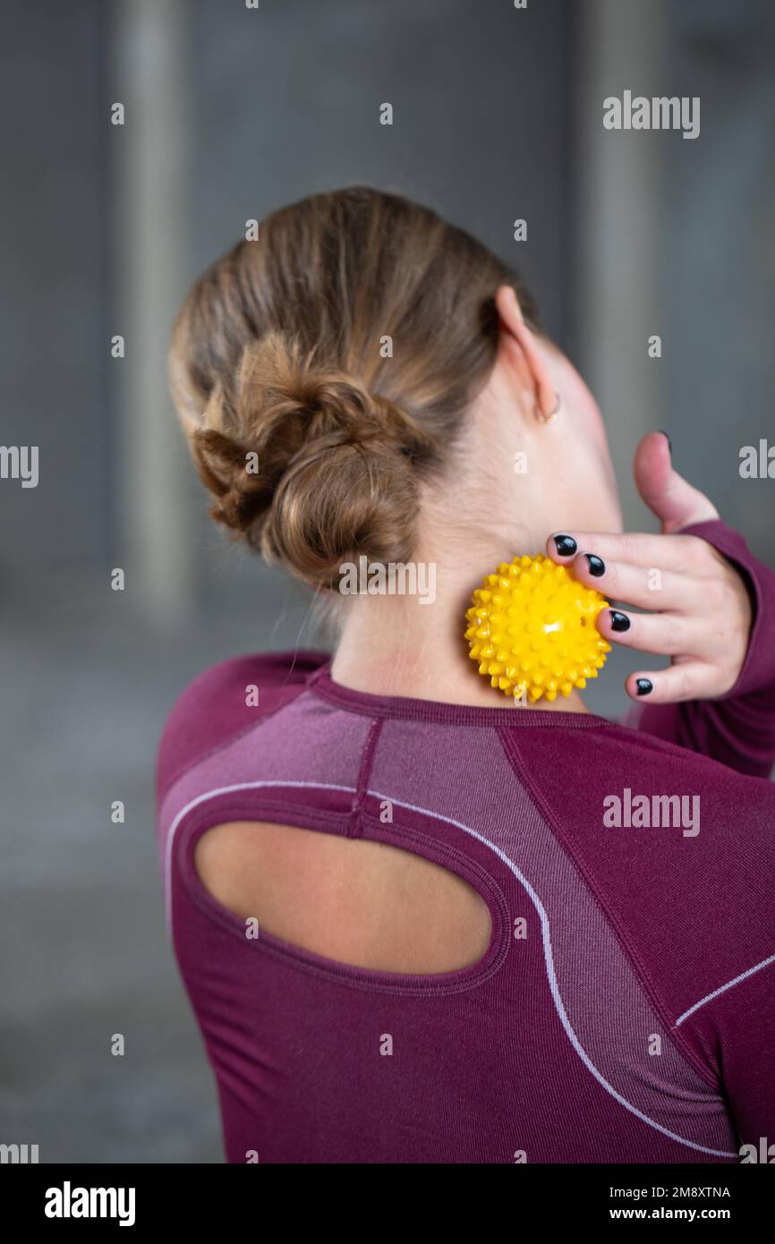 The athlete does a relaxing massage of the neck and back with the help ...