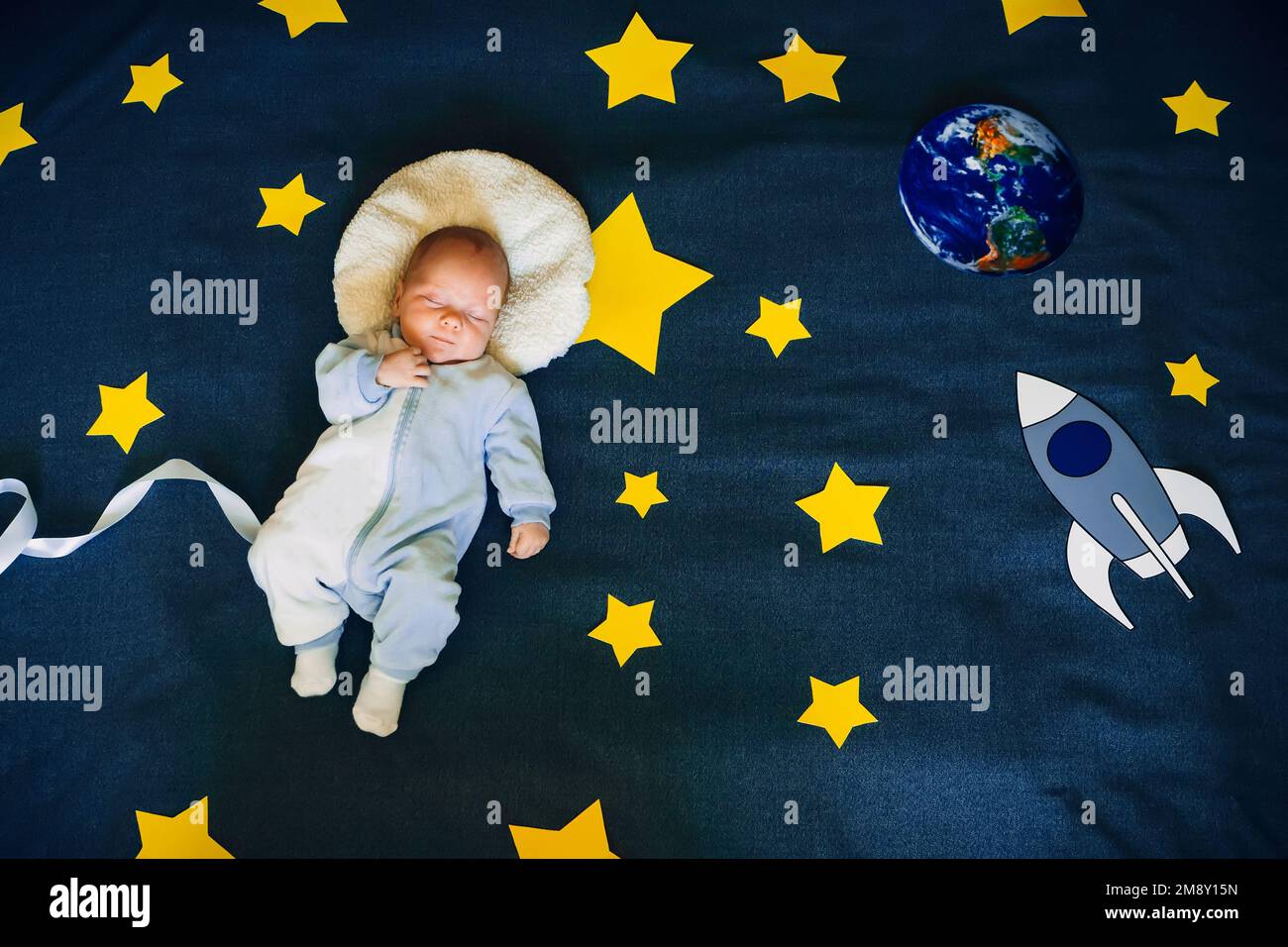 cute little toddler astronaut boy sleeping in the background of the sky ...