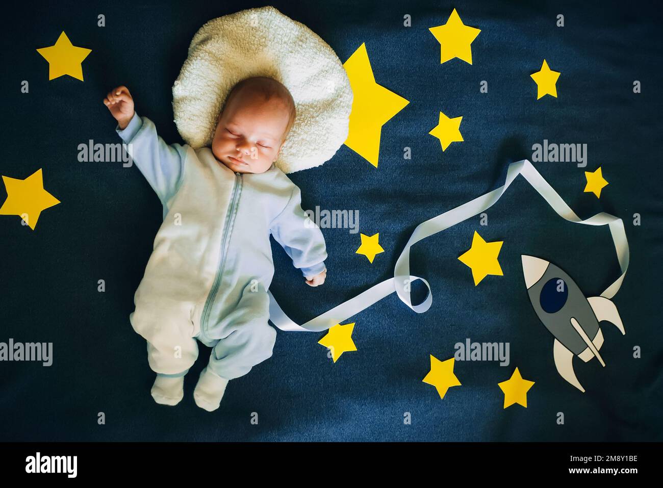 cute little toddler astronaut boy sleeping in the background of the sky ...