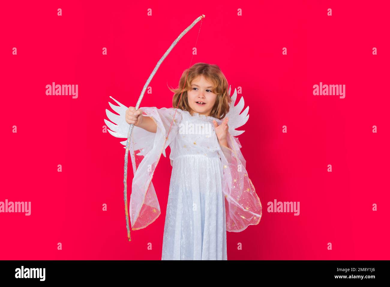 Angel kid shoots a love arrow from a bow on Valentines Day. Child at ...