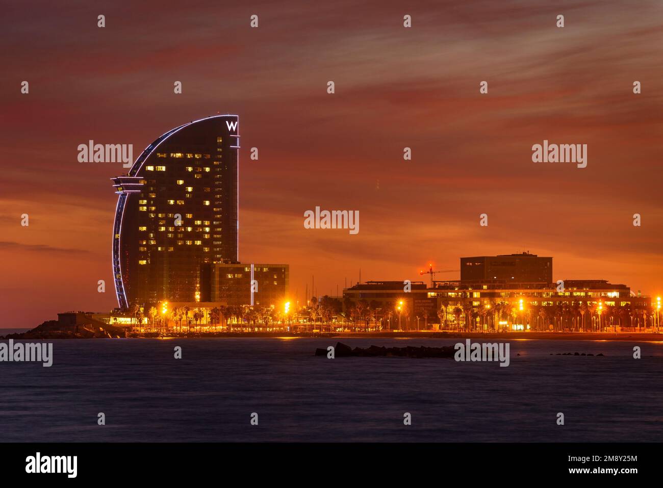 Hotel W Vela at twilight and at night, seen from the Barceloneta beach ...