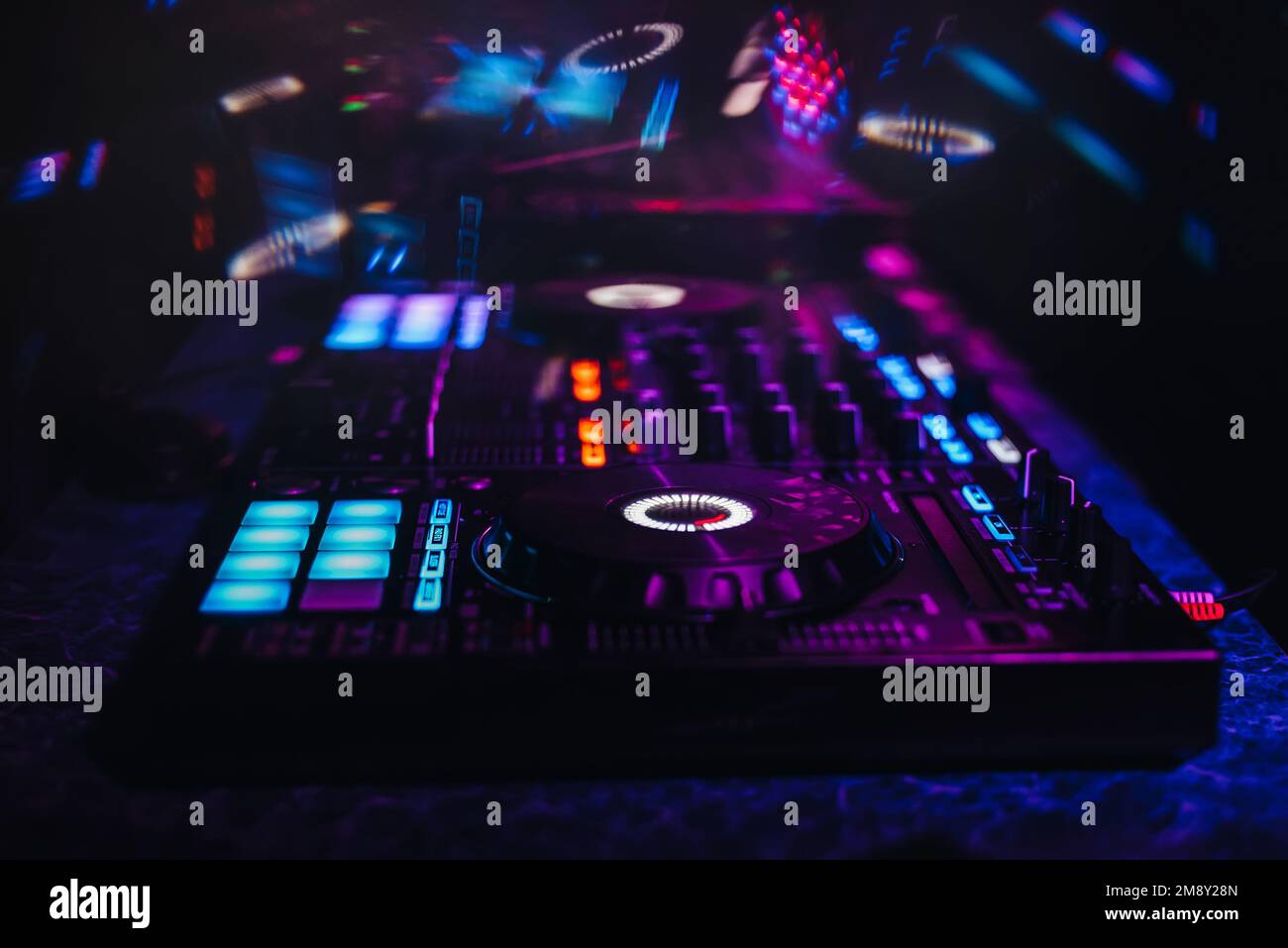 DJ mixer controller panel for playing music and partying in a nightclub ...