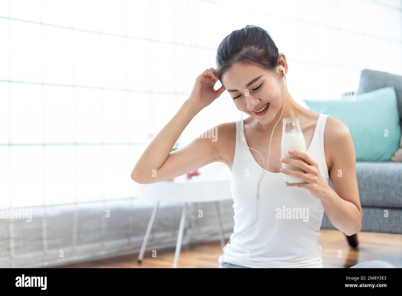 The young woman rest to drink milk after exercise Stock Photo - Alamy