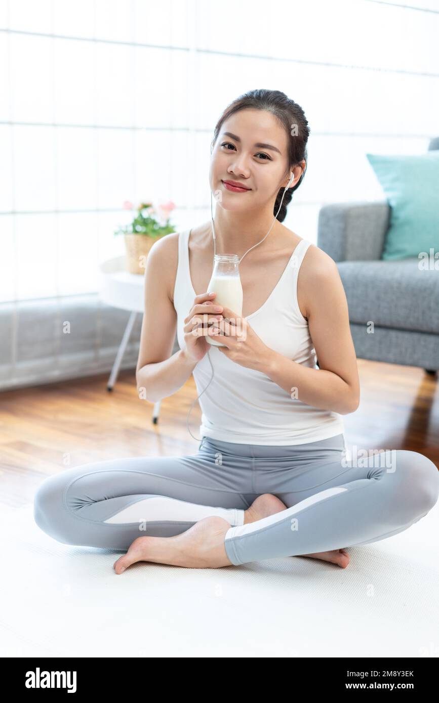 The young woman rest to drink milk after exercise Stock Photo - Alamy