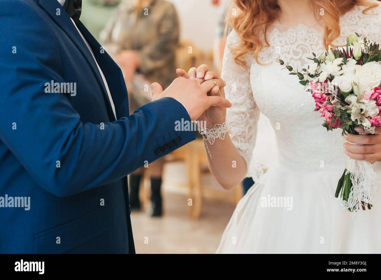 wedding ceremony of exchange of gold rings between the bride and groom ...
