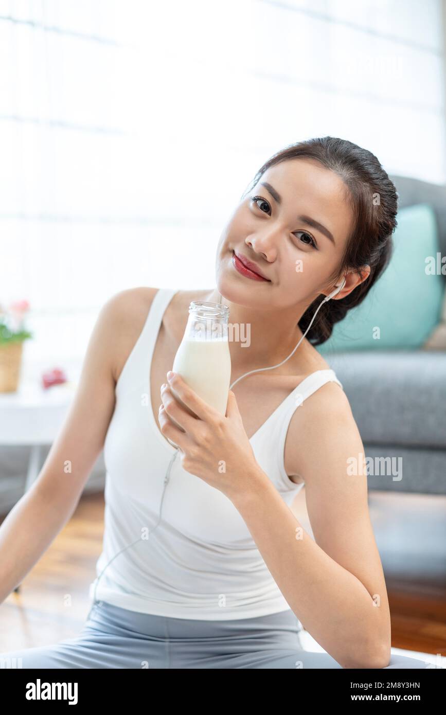The young woman rest to drink milk after exercise Stock Photo - Alamy