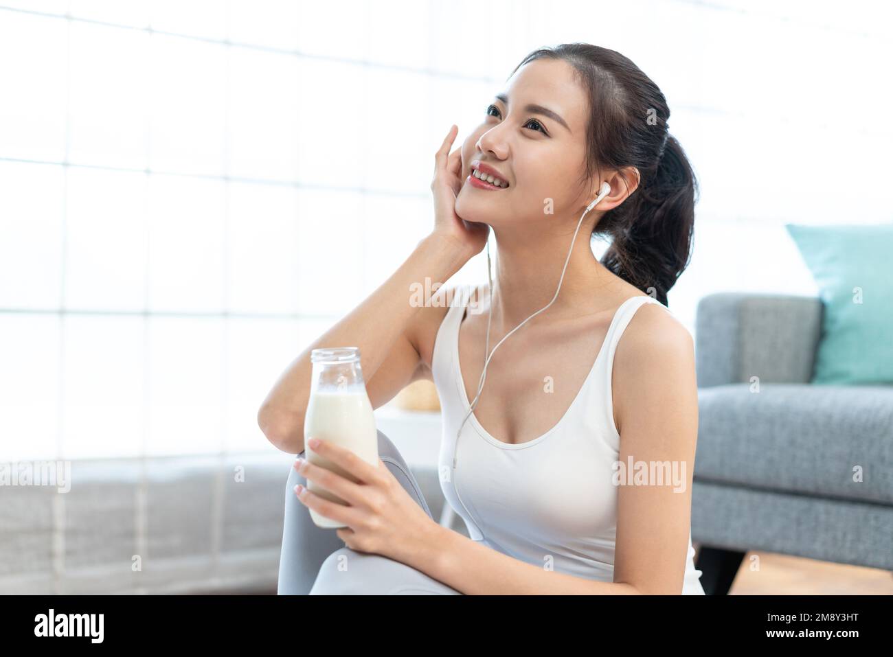 The young woman rest to drink milk after exercise Stock Photo - Alamy