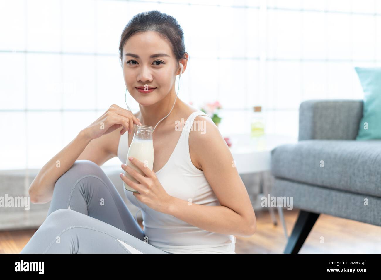 The young woman rest to drink milk after exercise Stock Photo - Alamy