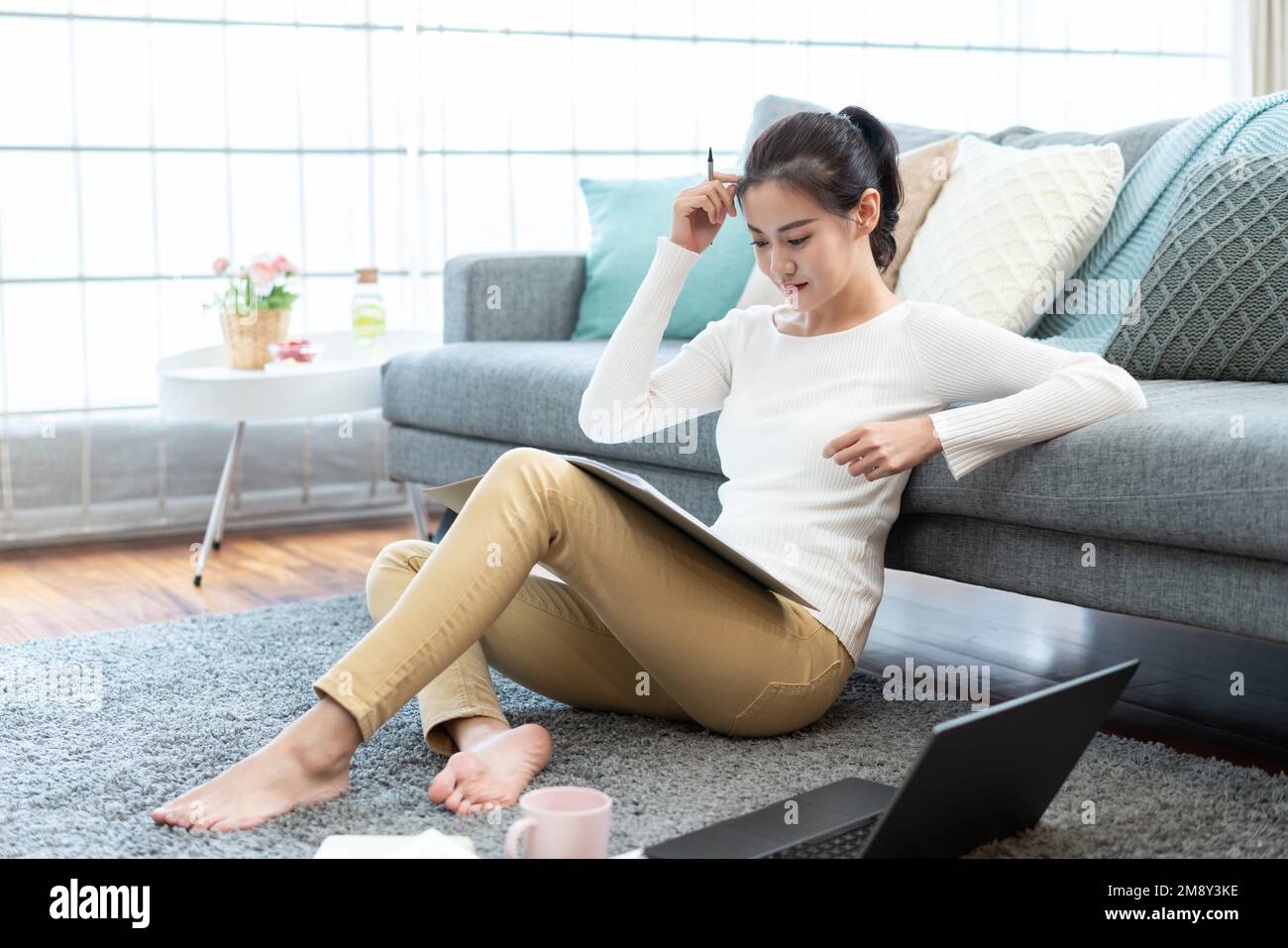 A young woman to use a computer at home Stock Photo - Alamy