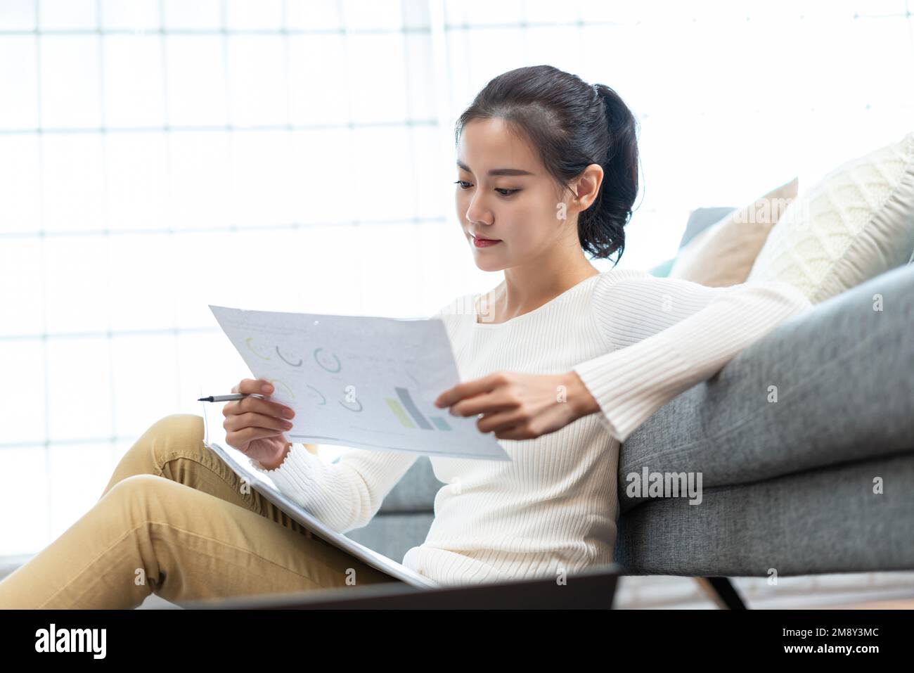 A young woman to use a computer at home Stock Photo - Alamy