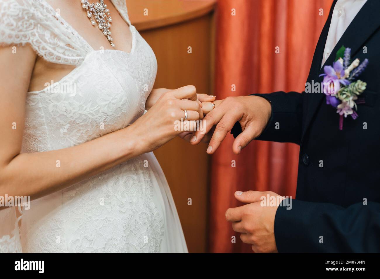 traditional wedding ceremony of exchange of gold rings between the bride and groom. Vows to ...