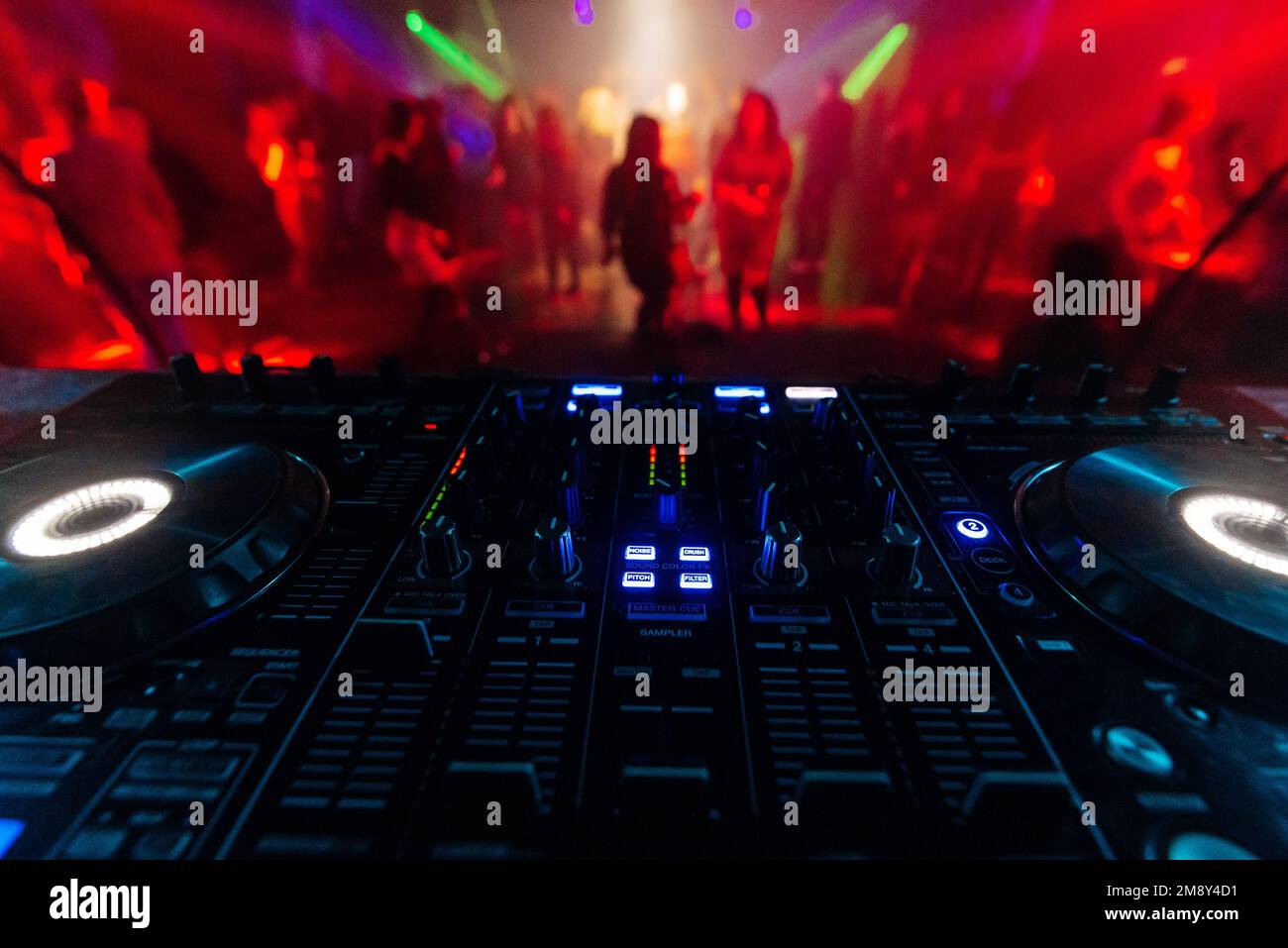 professional DJ mixer controller for mixing music in a nightclub with ...