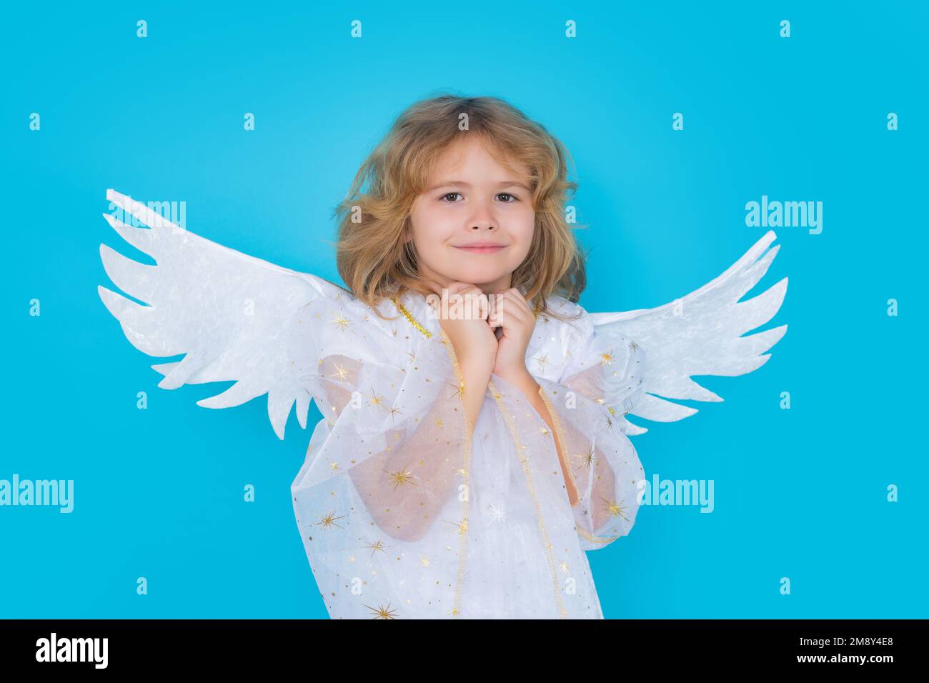 Little cute child at angel costume on isolated background. Kid with ...