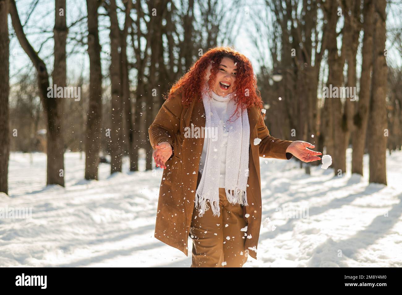 Fat caucasian woman playing snowballs in the park Stock Photo - Alamy