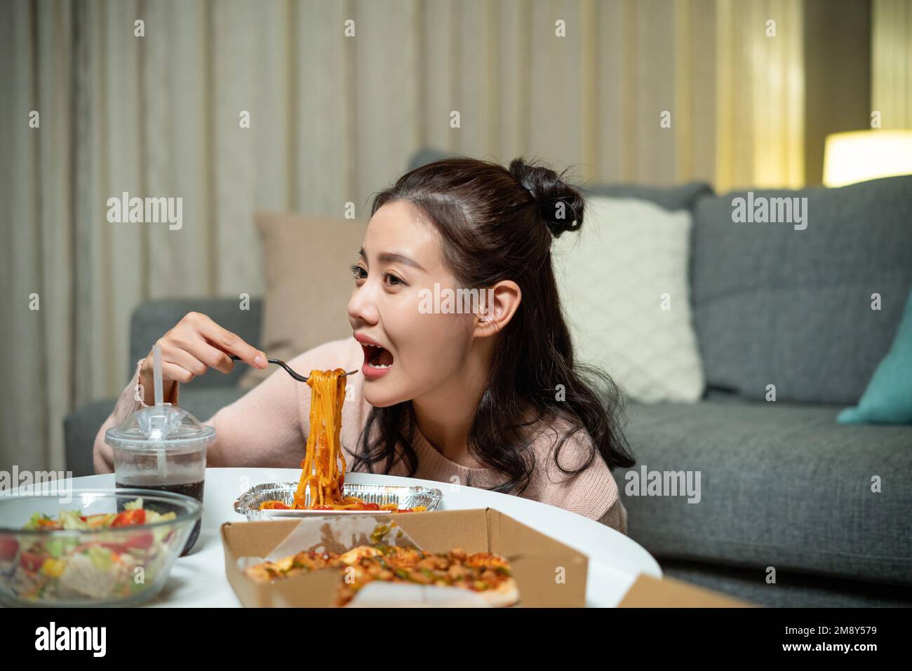 Woman only watching tv and eating hi-res stock photography and images ...