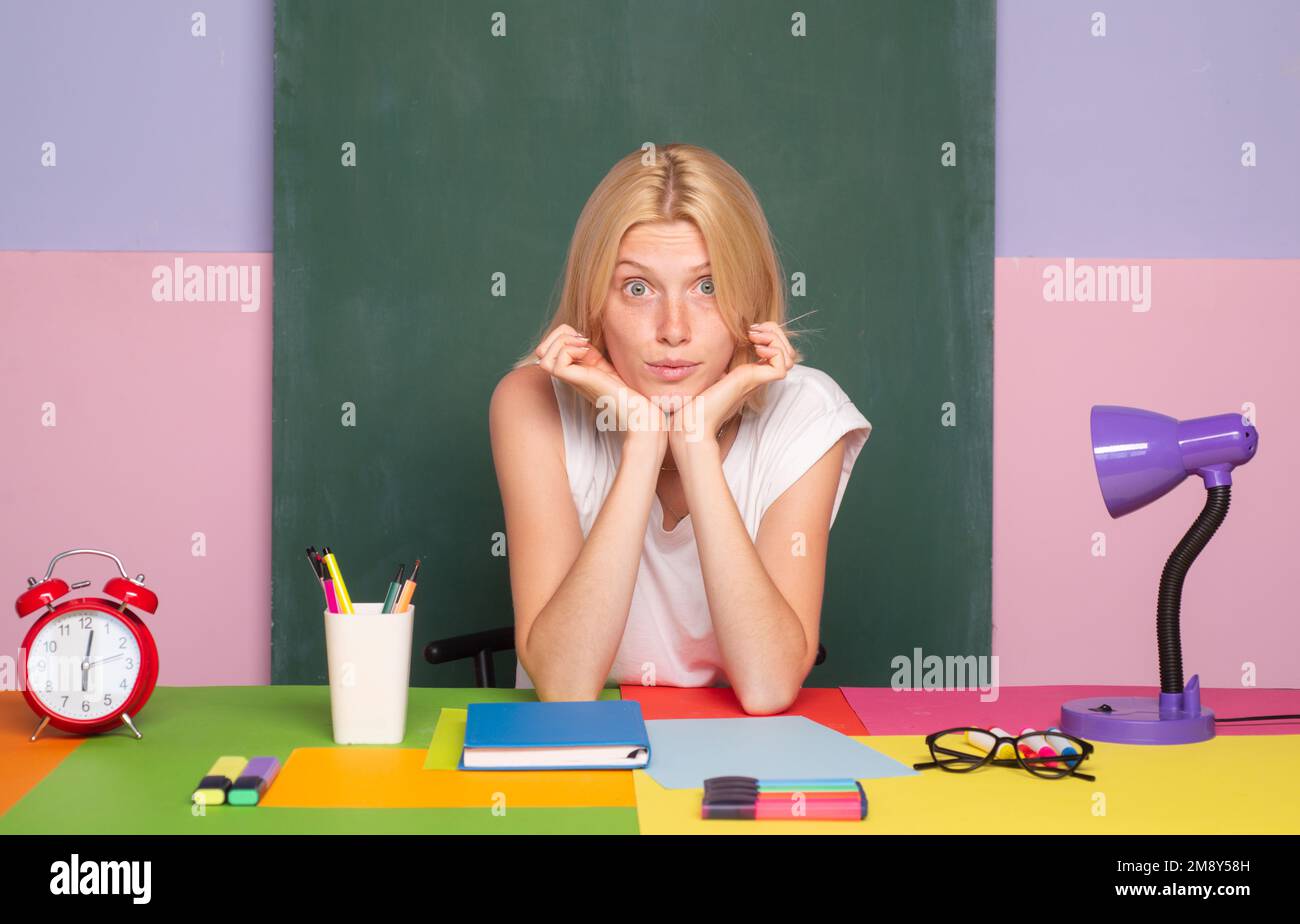 Portrait of confident female teacher near blackboard in classroom at ...