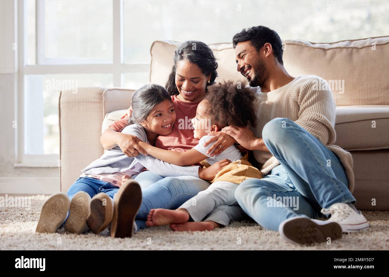 Affectionate and loving mixed race family sitting together. Happy ...