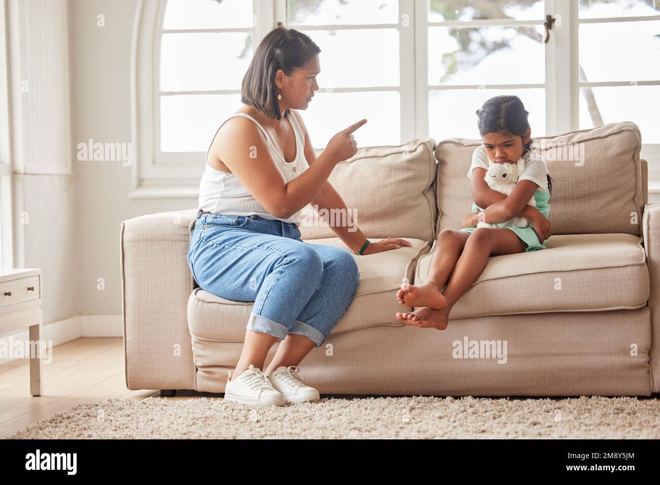 Angry mother yelling at her naughty child about bad behaviour and ...