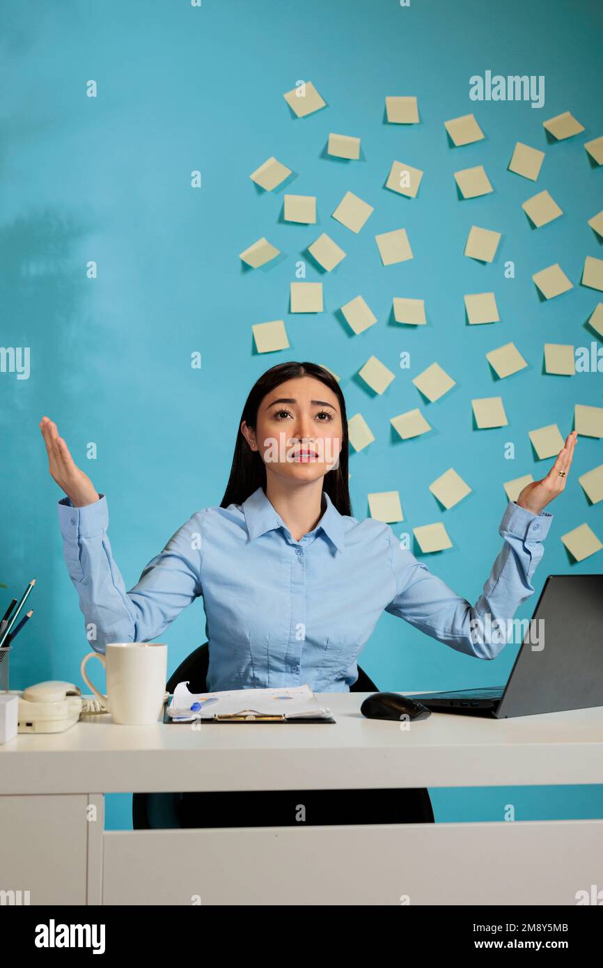 Spiritual woman company employee meditating from her work place ...