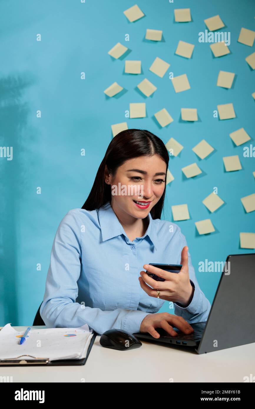 Female corporate employee making online bill payment by credit card ...