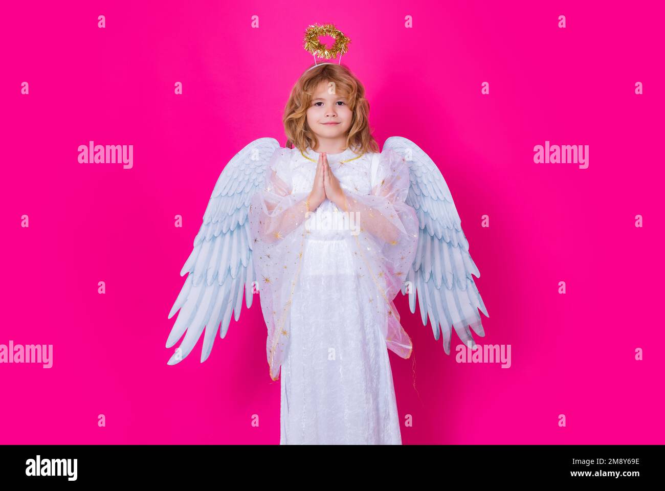 Angel prayer. Child at angel costume with prayer hands, hope and pray ...